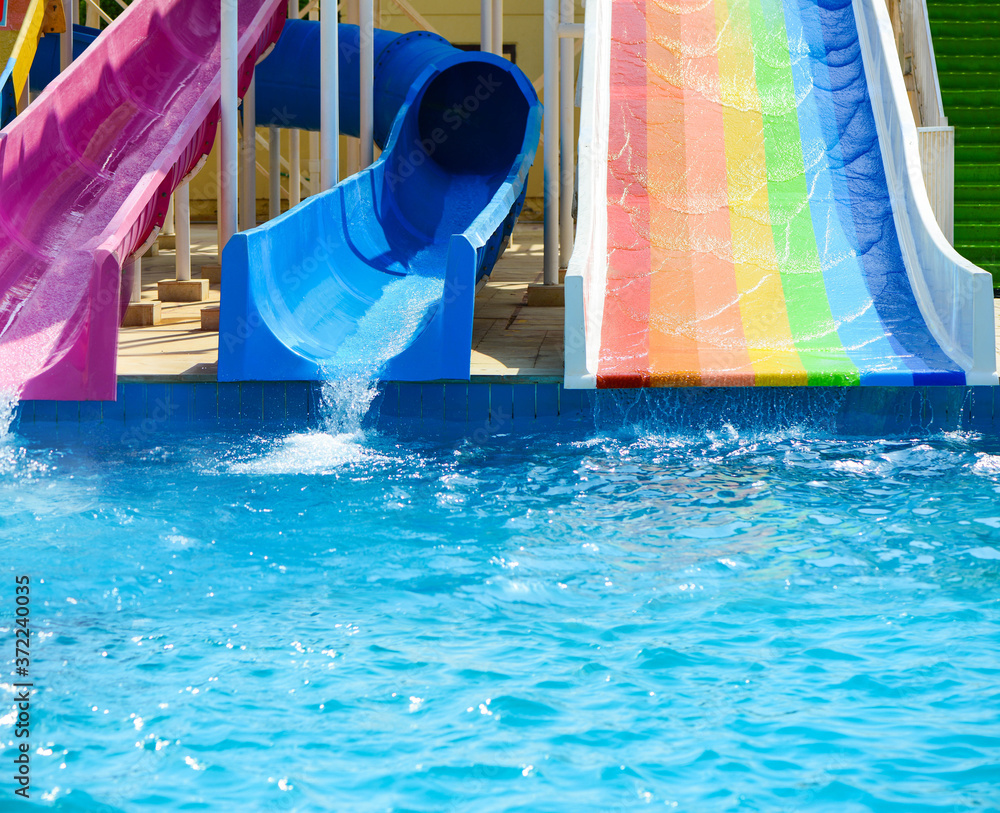 water sliding down in pool from summer aqua park sliders background ...