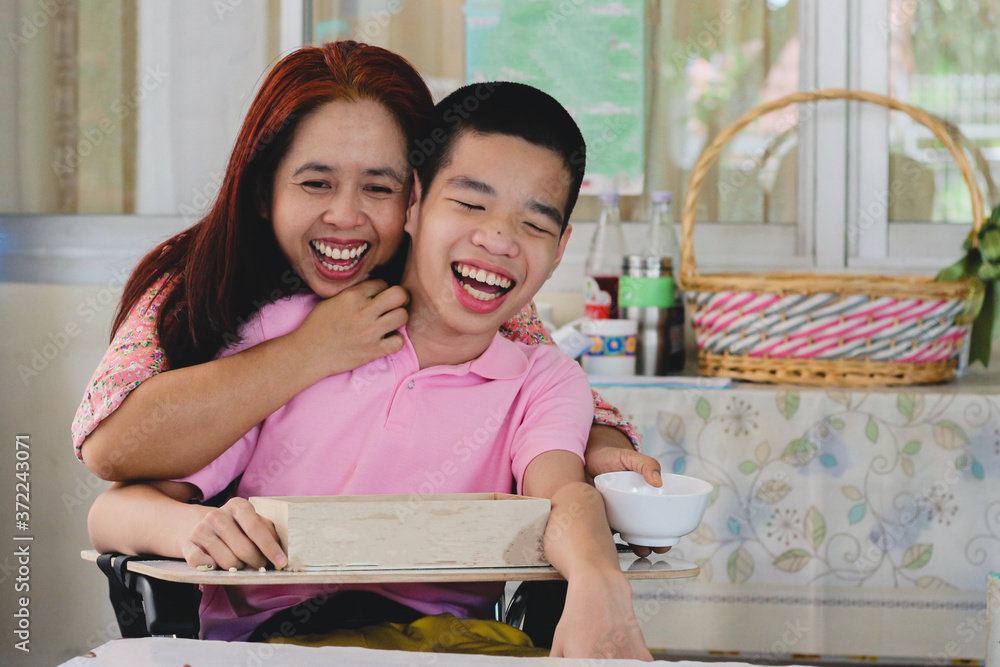 Mom and Disabled child on wheelchair doing muscle training activities ...