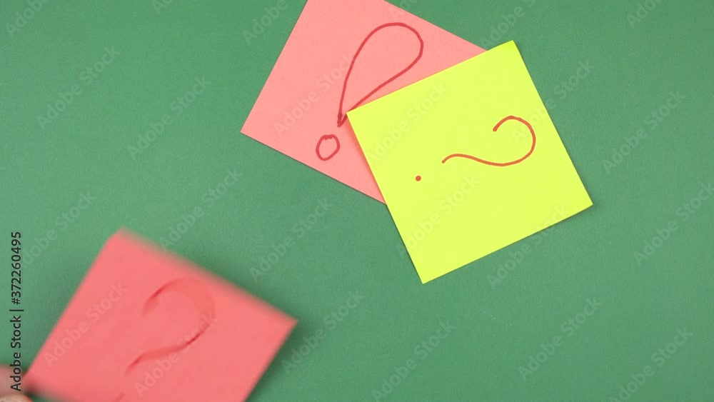 a note with exclamation marks and question marks. Sticky note with ...