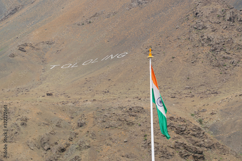 Indian national flag is waving in the bottom of mount Tololing ...