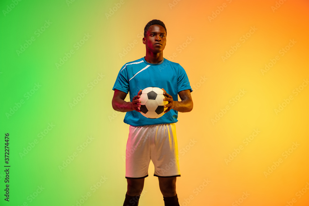 Stunning. African-american male soccer, football player training in ...