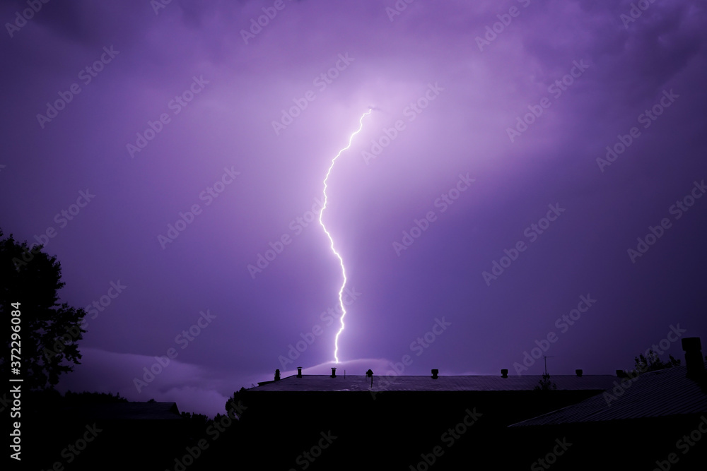 Lightning storm over the city at the summer heavy rain. Dramatic ...