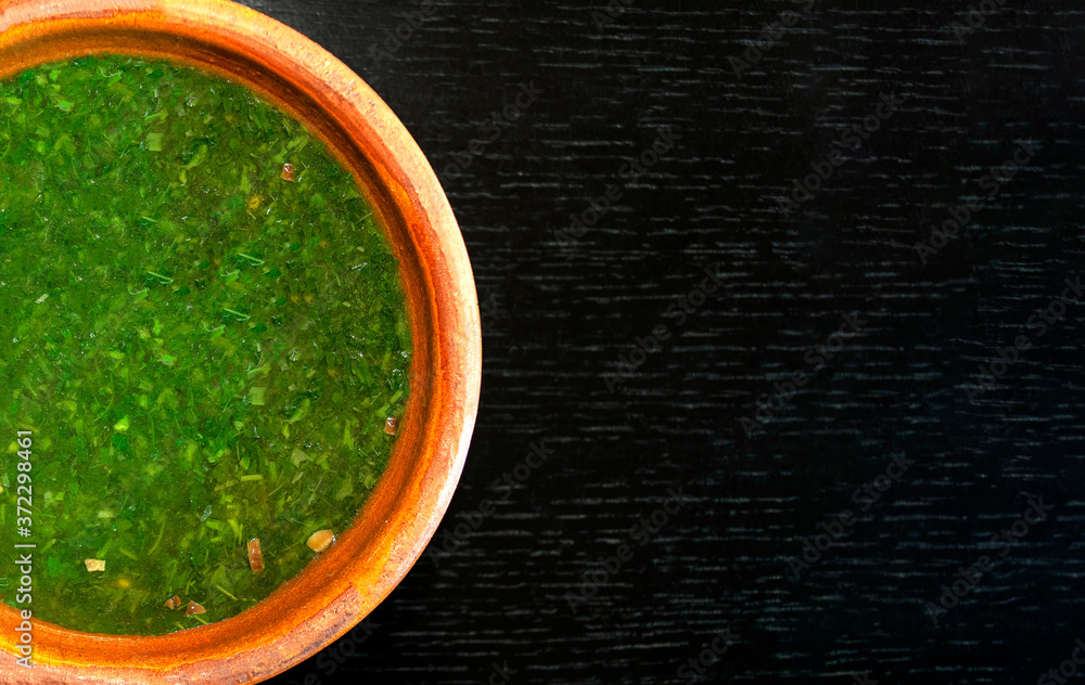 Famous traditional Arabic cuisine. Molokhia soup in brown bowl on dark ...