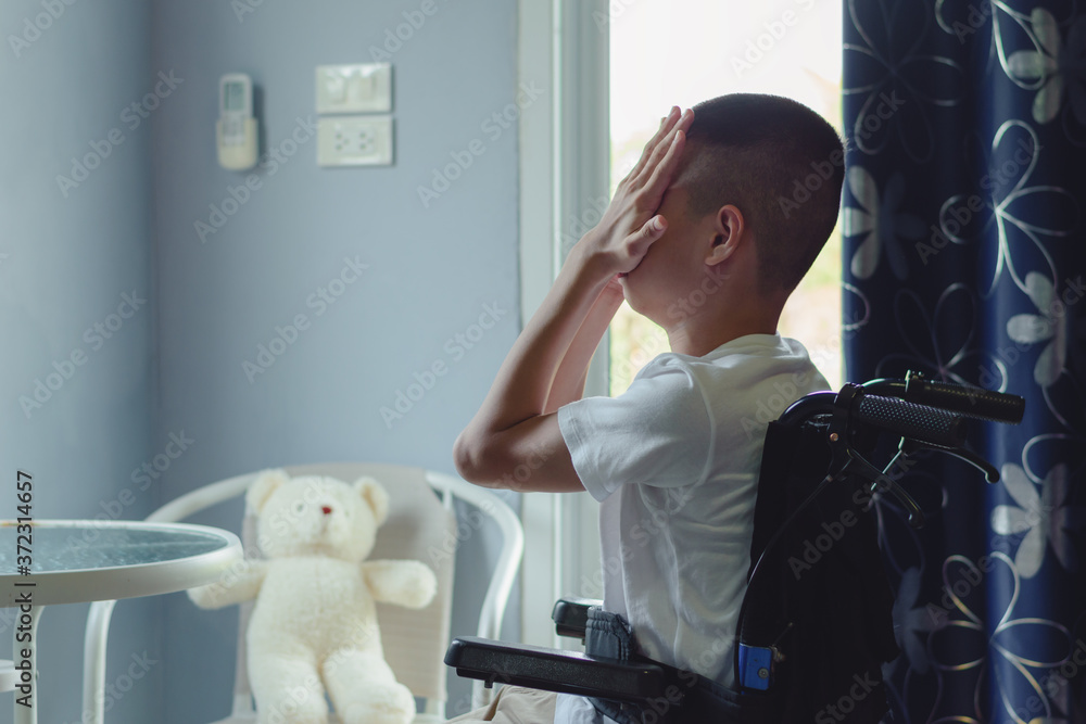 Asian special child on wheelchair with his good friend is teddy bear ...