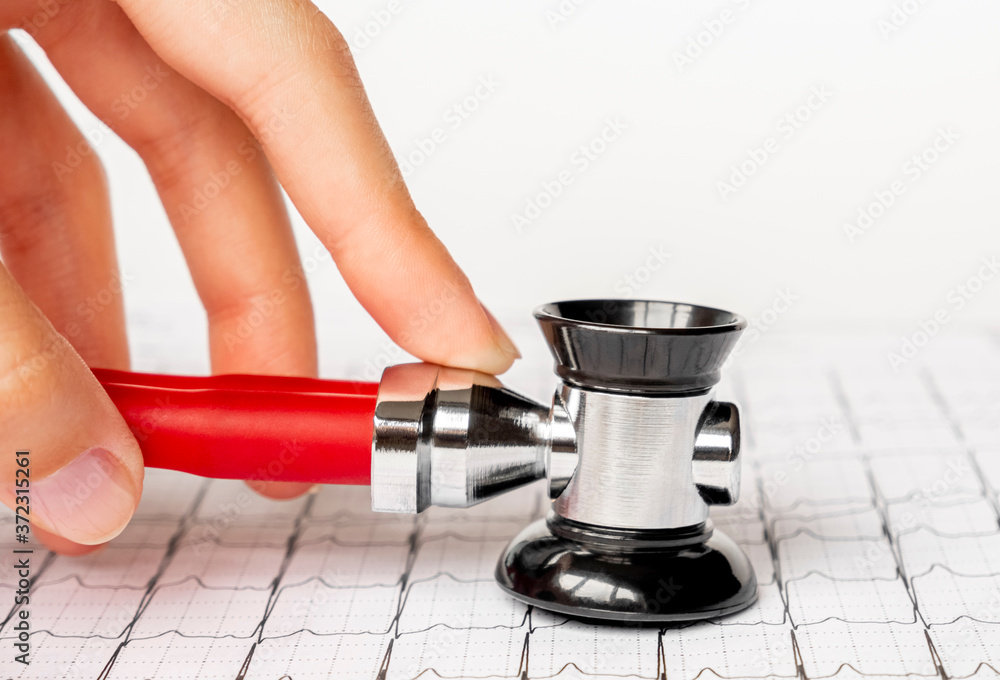 Photo of an electrocardiogram ECG or EKG printout with stethoscope ...