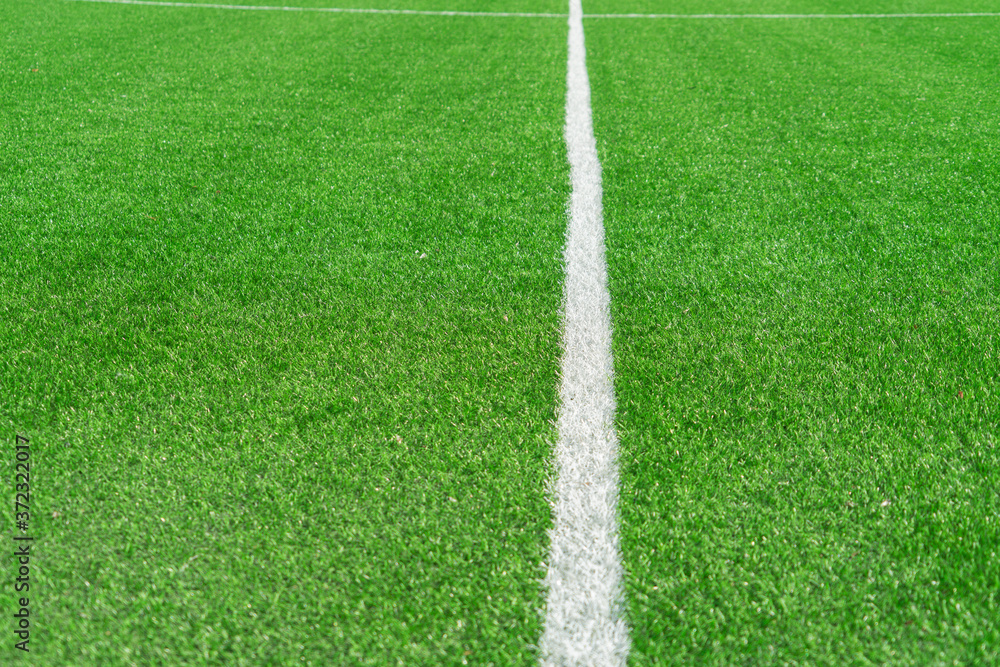 Green artificial grass turf soccer football field background with white ...