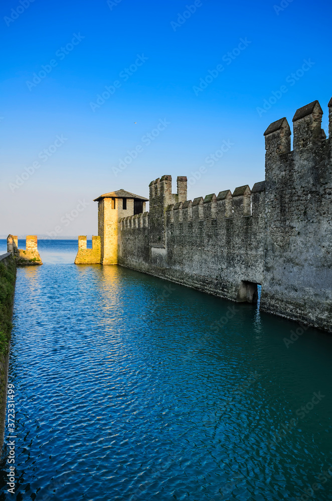 Rocca Scaligera. Unique 13th-century castle surrounded by water, with ...