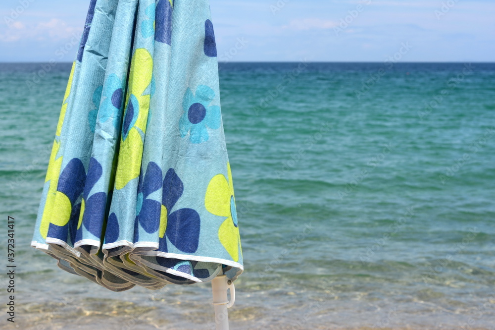 Colorful holiday background. Beach umbrella near the water. Beach ...