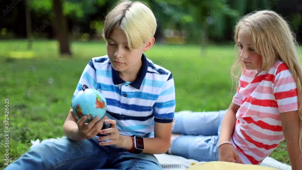 Kids using smartwatch tapping touchscreen looking up. Shot for ...