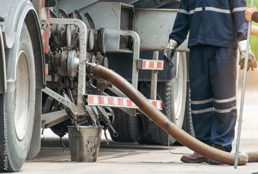 Fueling Up a Freight Transport Truck, oil and gas workers fueling large ...