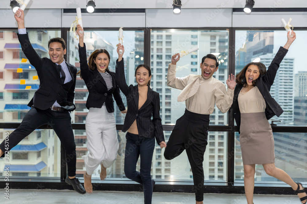 Business office workers celebrate a great acheivement together after ...