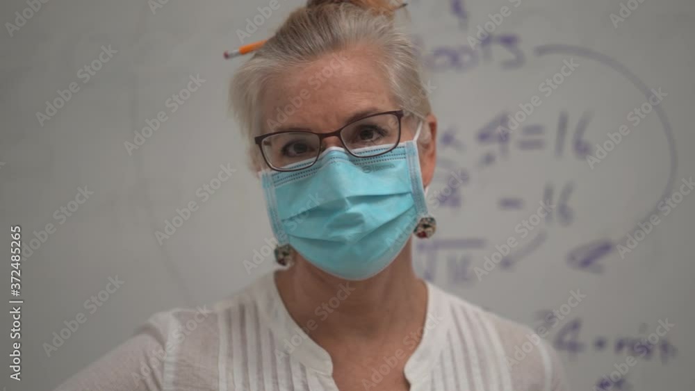 Closeup portrait of sad mature woman math teacher wearing medical face ...