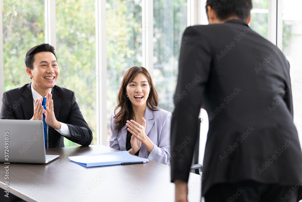 asian business group clapping hands for congratulations on colleague ...