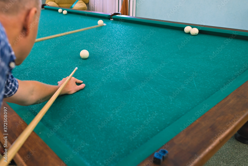 Man's hand and arm playing pool preparing to shoot the white ball of a ...