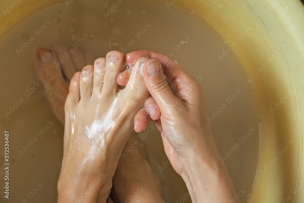 female feet in soapy water, washing in a plastic bowl Stock Photo ...