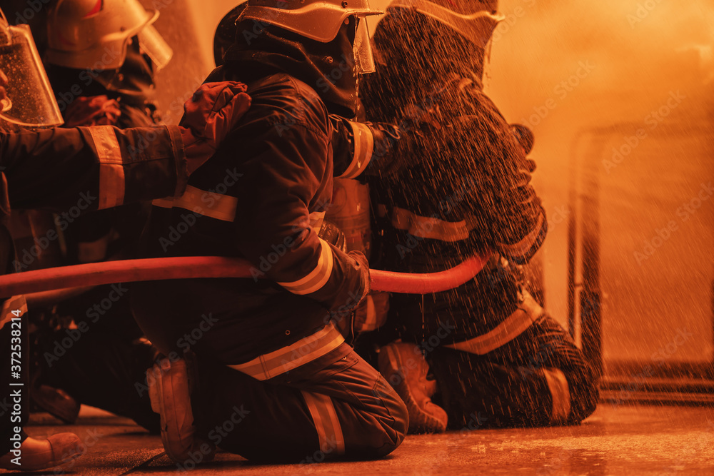 Firefighter using extinguisher or Twirl water fog type fire ...