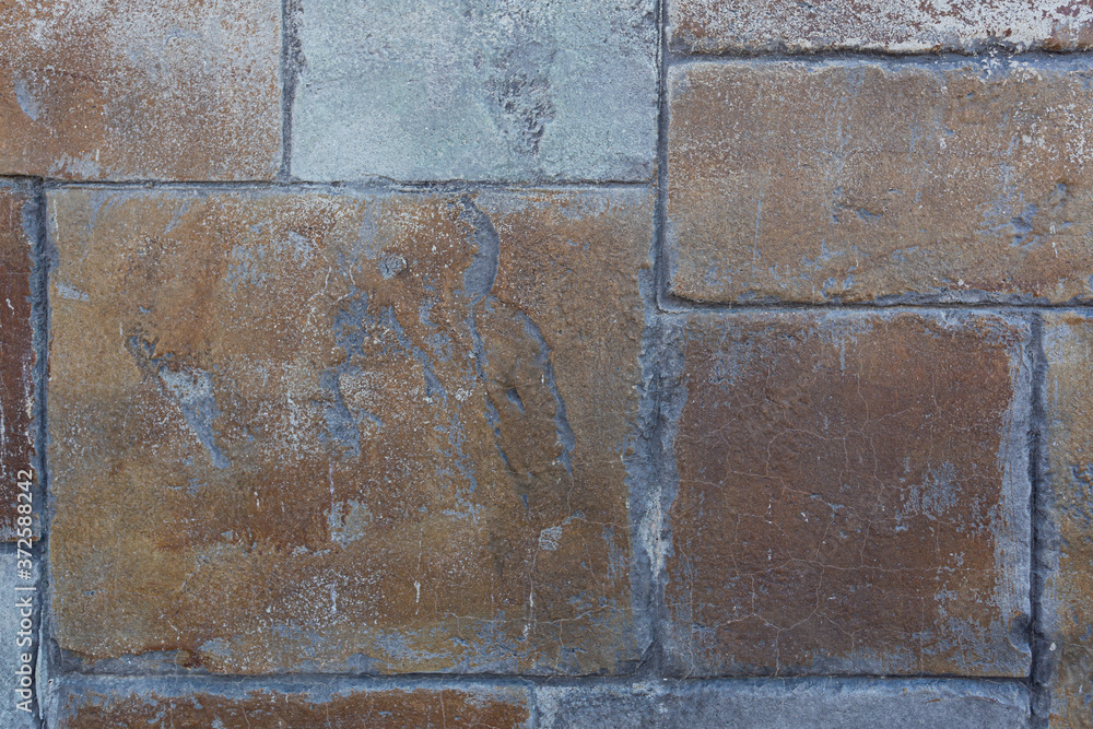 linear stone wall built with cement in red yellow and orange Stock ...