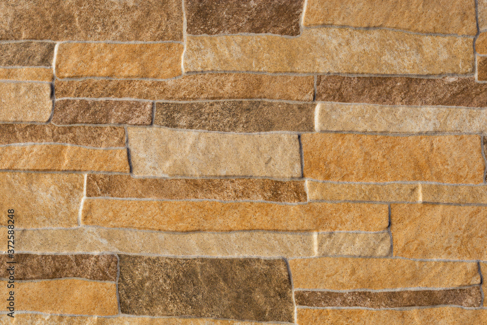 linear stone wall built with cement in red yellow and orange Stock ...