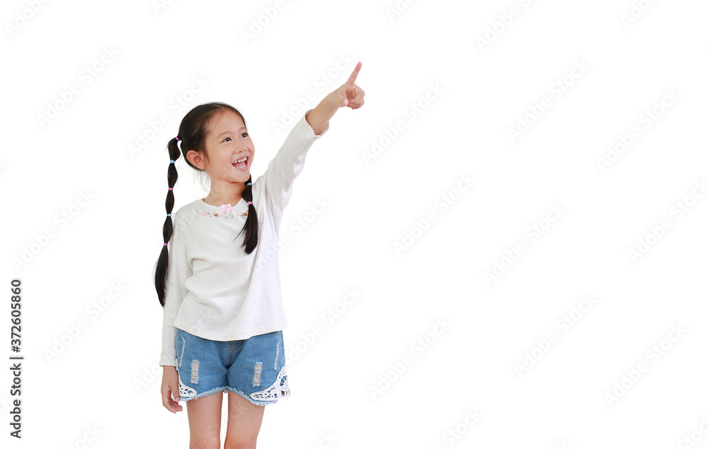 Portrait smiling asian little child girl point index finger up isolated ...