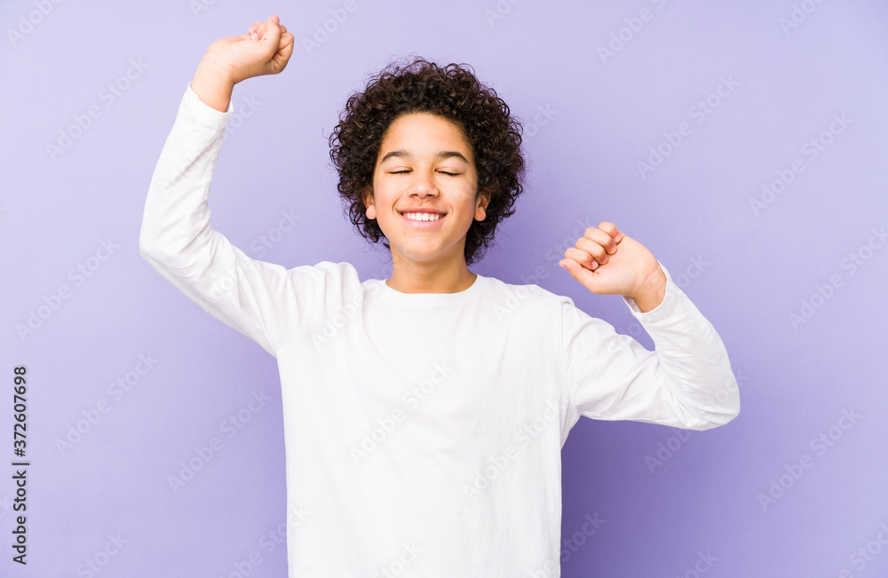 African american little boy isolated celebrating a special day, jumps ...