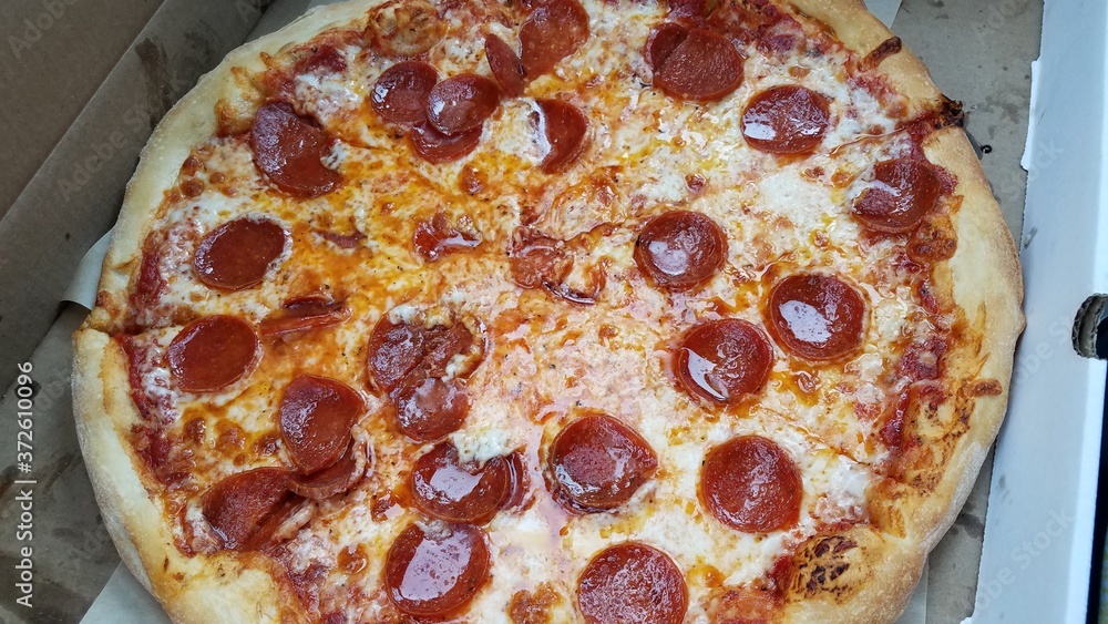 greasy hot pepperoni and cheese pizza slices Stock Photo | Adobe Stock