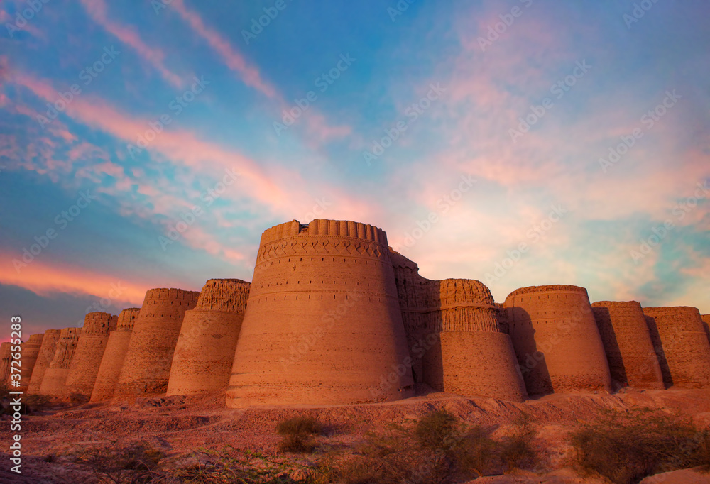 fort with beautiful orange clouds and blue sky in the desert, derawar ...