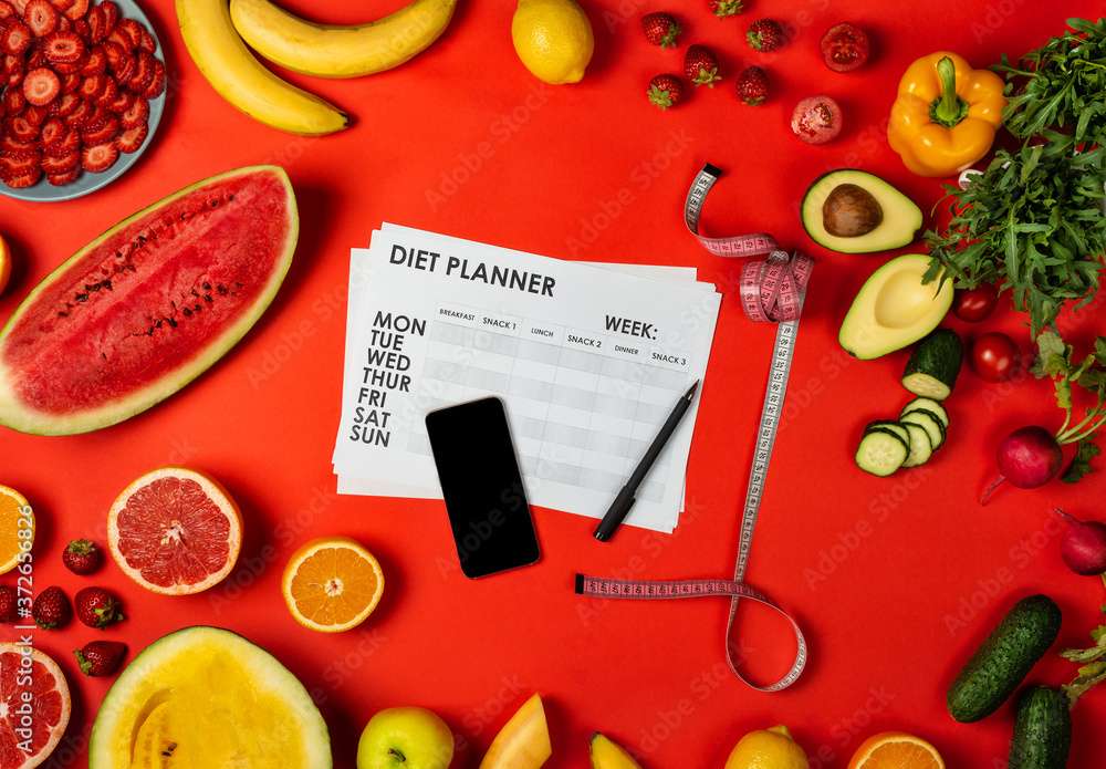 Smartphone and diet plan with measuring tape and set of healthy food ...