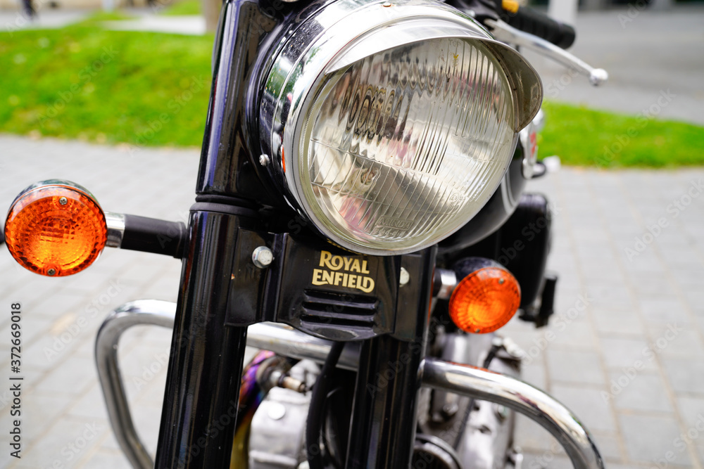 Royal Enfield logo sign front of motorcycle closeup with headlight on ...