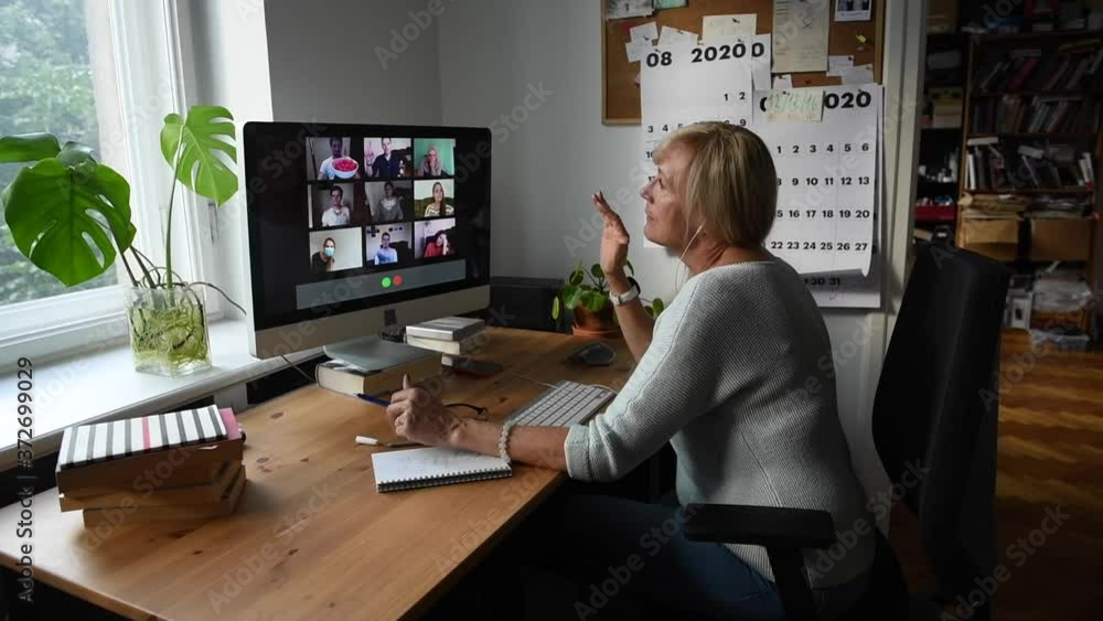 Woman having Zoom video call via a computer in the home office. Stay at ...