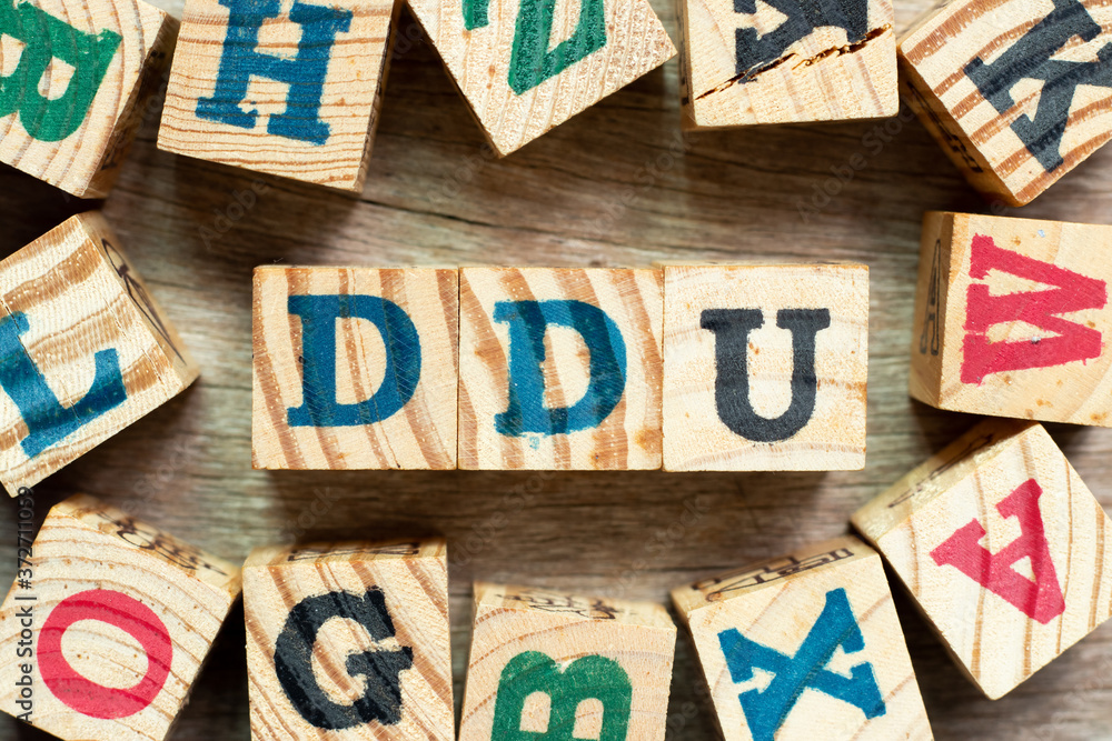 Alphabet letter block in word DDU (abbreviation of Delivered Duty ...