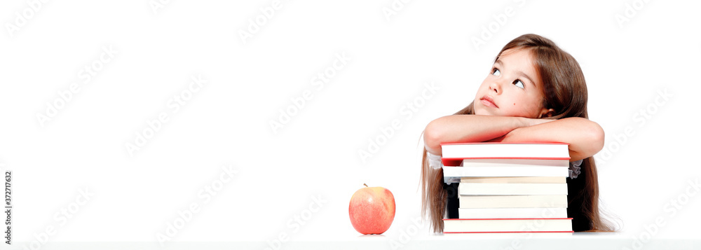 Cute little child girl looking up on the desk at school. Stock Photo ...