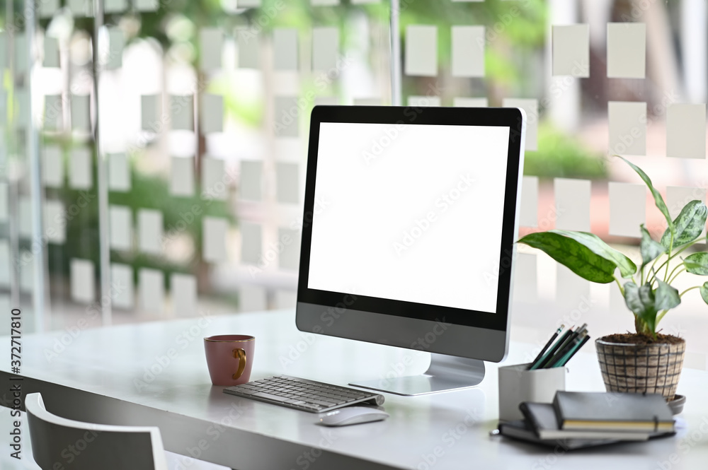 A computer monitor with a white blank screen is putting on a working ...
