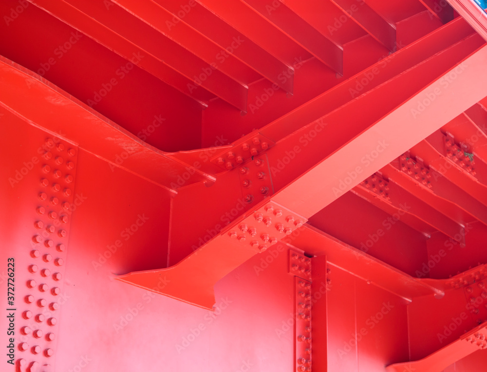 The red iron beam is bolted down. Close-up shows the connection of the ...