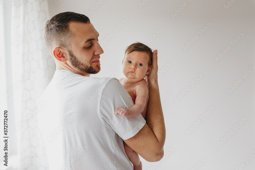 Happy Caucasian father holding newborn baby. Proud man parent rocking ...
