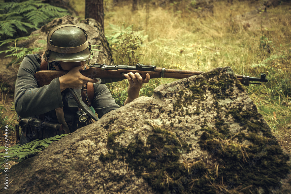 Military reenactor of the second world war, shooting a rifle in the ...