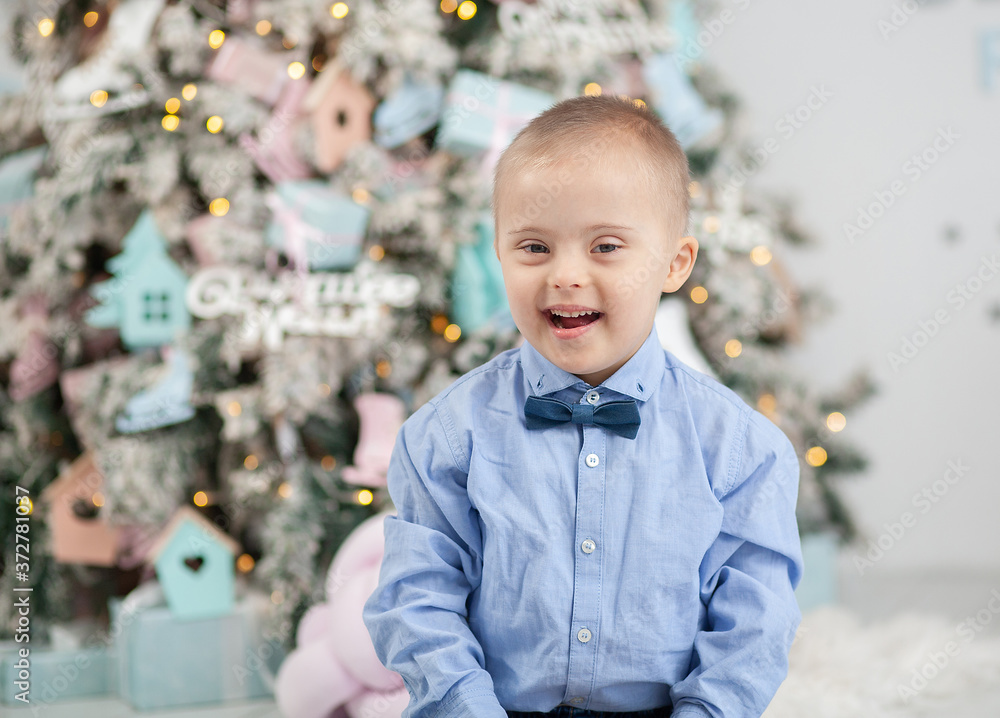 Fotografia do Stock: A little boy with Down syndrome at the New Year's ...