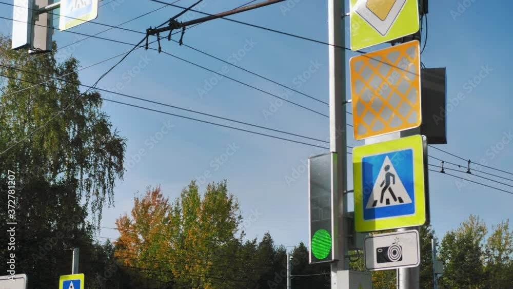 Close-up of traffic lights and road signs at an intersection in the ...