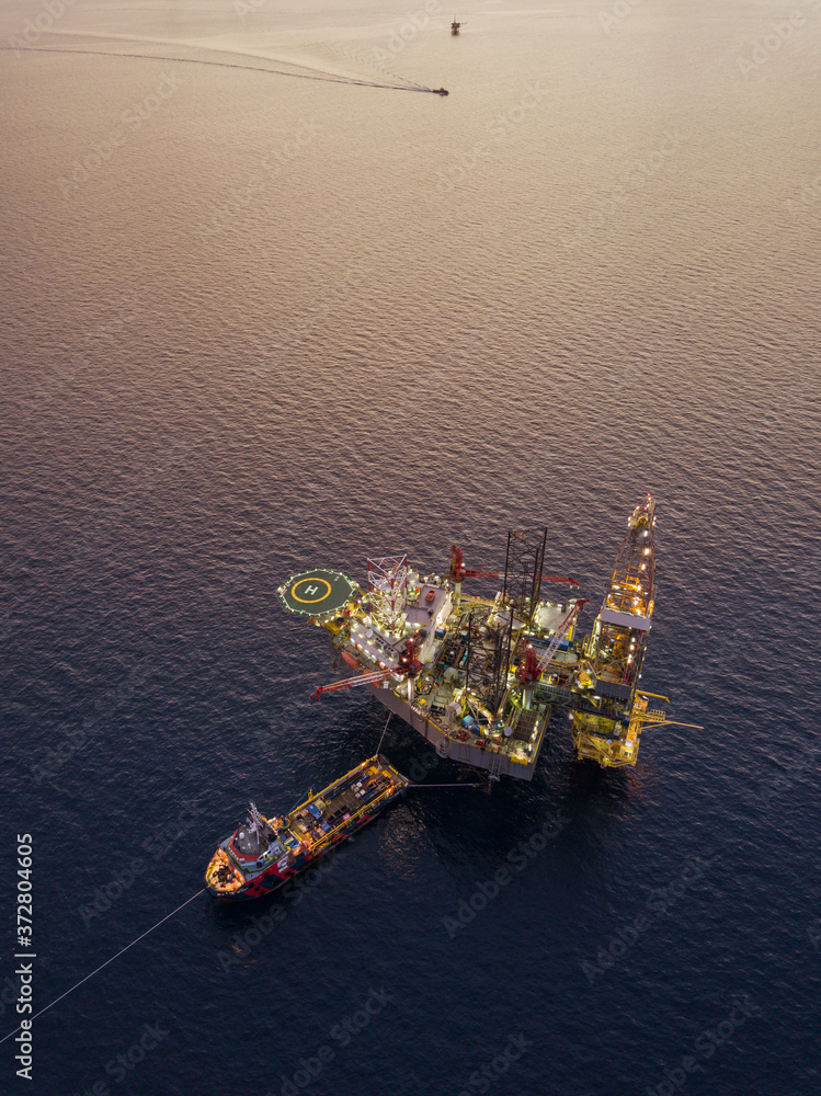 Aerial view offshore jack up rig at the offshore location during sunset ...