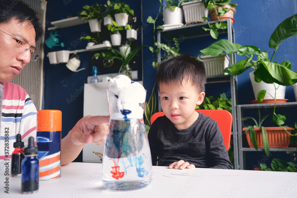 Parent sitting homeschooling with little kid, Father and son having fun ...