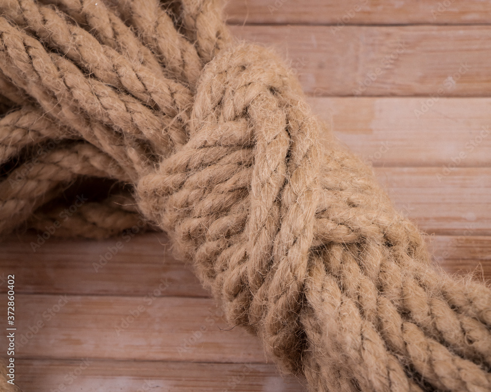 Coiled hemp shibari rope with ends and bight locked with tuck under ...