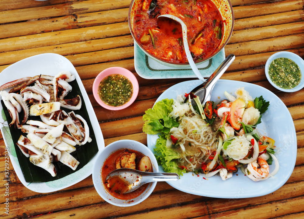 random seafood menu on wooden table (seafood vermicelli spicy salad ...