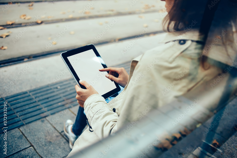Cropped view of woman's hands holding digital touch pad in hands and ...
