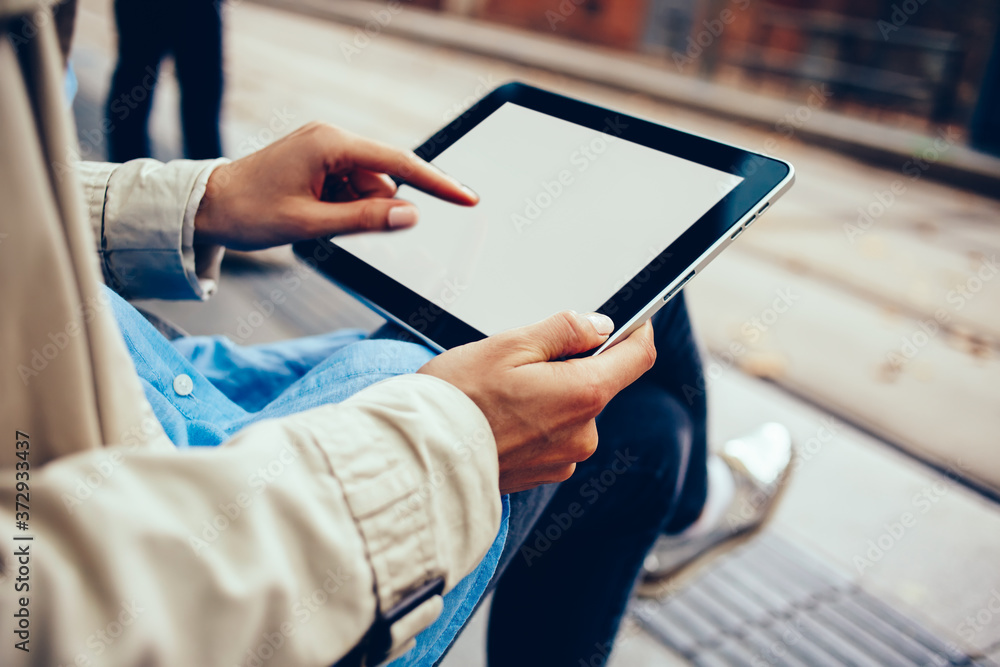 Cropped view of young woman touching with finger on blank screen of ...