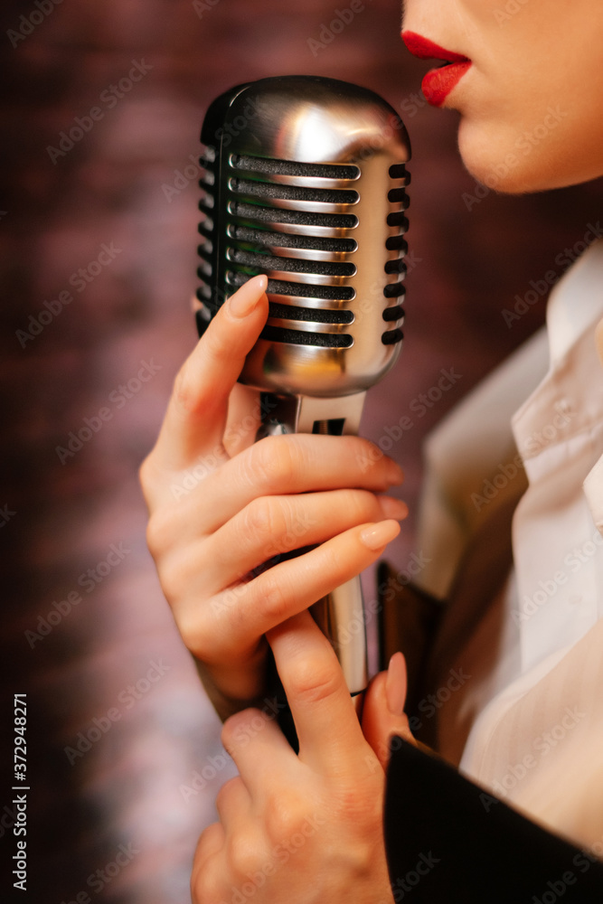 Singer lips and retro microphone. Girl on stage holding a microphone ...