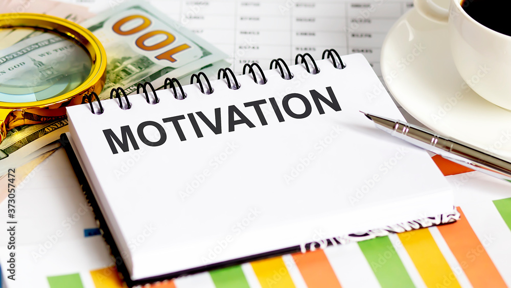 MOTIVATION text.Top view office table, Business graph show for ...