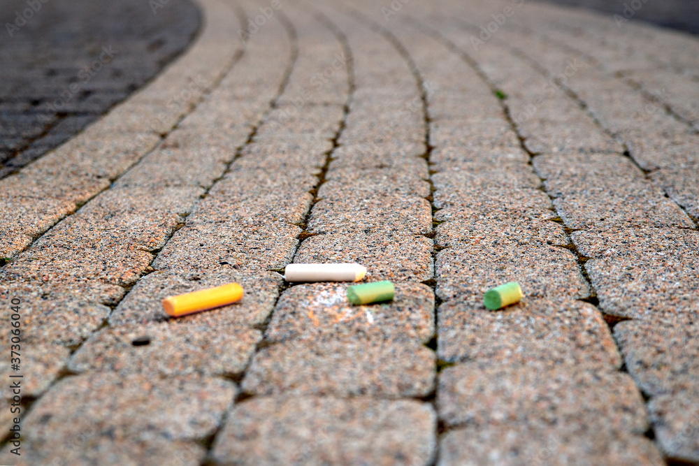 Colored chalk on playground with drawings on street.children drawing on ...