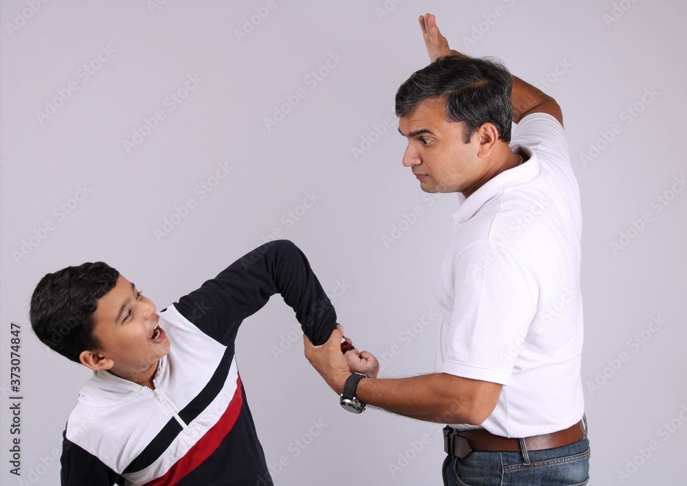 Indian father scolding his son. Stock Photo | Adobe Stock
