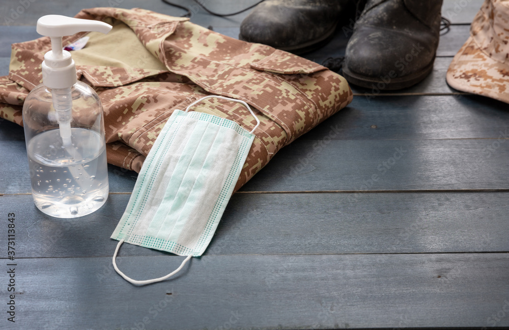 Army coronavirus protection concept. Hand sanitizer and US army gear on ...