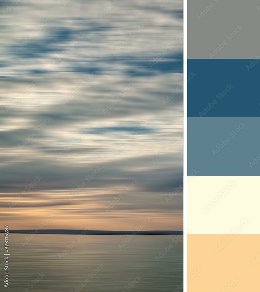 Beautiful azure blue sky with orange grey clouds above dark blue sea ...