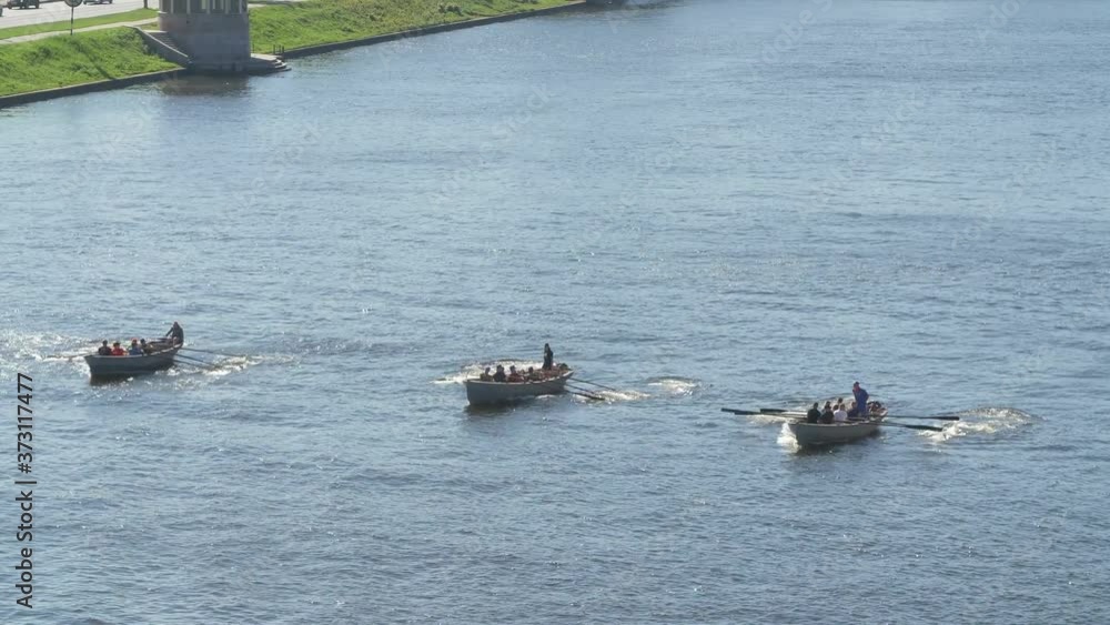 Sporting rowing team training. Tourists are rafting down the river in ...